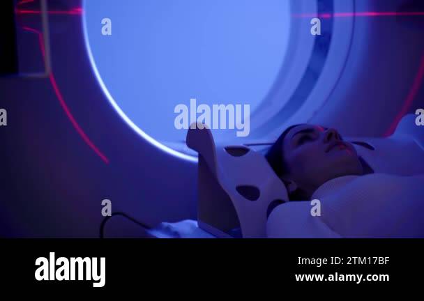 4k video CT scan of brains of woman in medical clinic with blue light ...