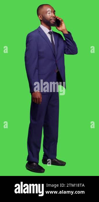 Vertical video: Side view of company employee talking on smartphone ...