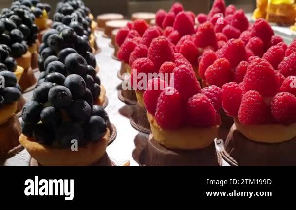 Blueberry rapsberry pile on custard tart beautiful bakery window ...