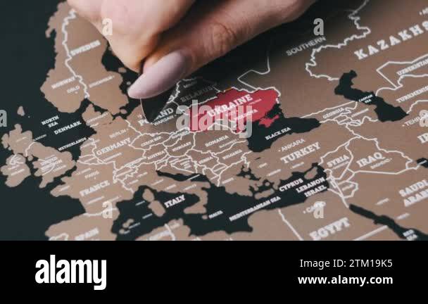 Female hand scratching the surface of a scratch map with Poland country ...