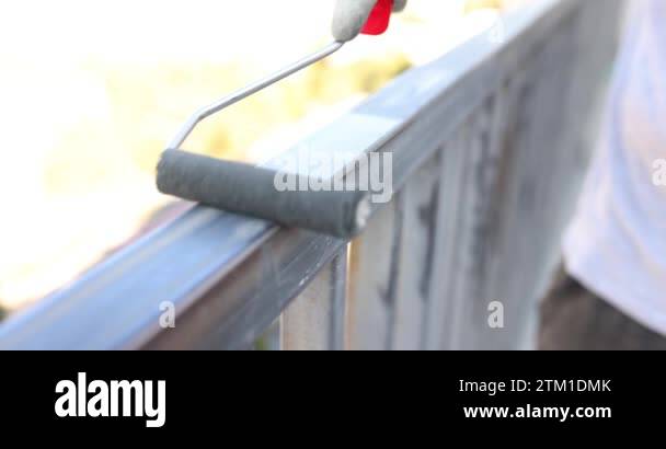 Painter paints metal parts gray with roller. Painting work in ...