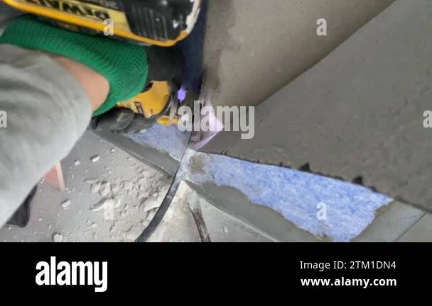 The builder makes a hole in the wall for laying electrical wires ...