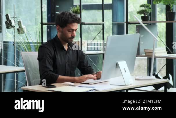 Middle Eastern entrepreneur in headset, collaborates with a colleague ...