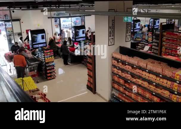 Customers stand in line at checkout counters in a supermarket. High ...