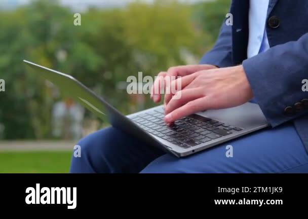 Close up footage of young man hands working on laptop tapping on ...