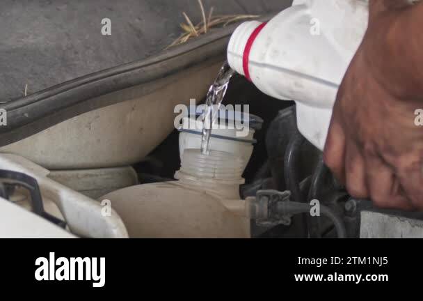 Filling An Old Car Engine With Coolant Water From A Canister Footage ...