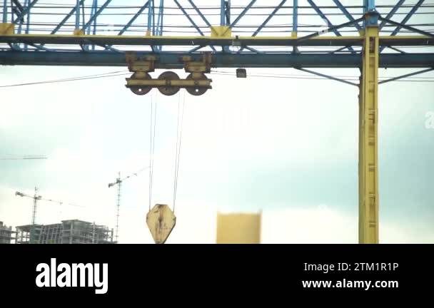 Gantry crane winches move on guides dragging heavy loads in production ...