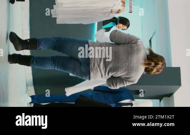 Vertical video: Happy customer going to fitting room to try on shirts ...