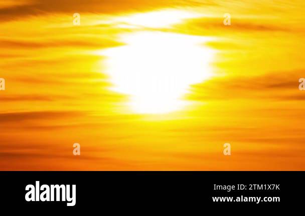 Time lapse bright orange sunset sun sets behind the clouds. The end of ...