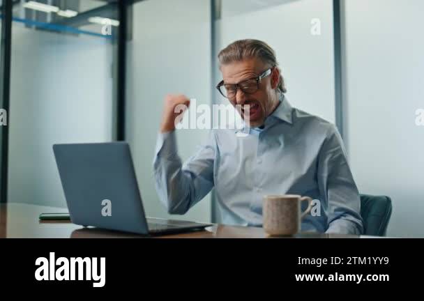 Excited businessman rejoicing laptop at office closeup. Happy leader ...