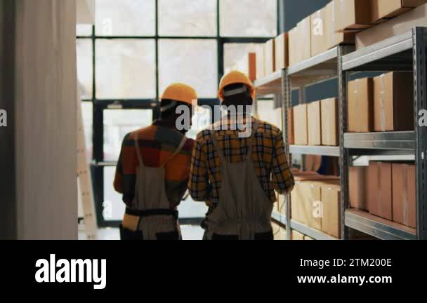 Team of employees working on logistics with scanner and list of goods ...