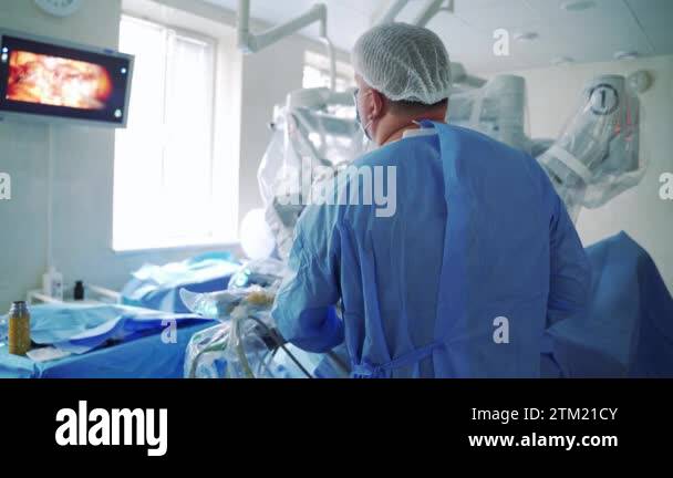 Endoscopic operation in surgery room. Surgeon man looks at the screen ...