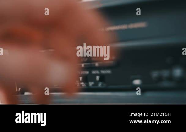 Male hand pulls out VHS from a vintage videotape recorder. Eject VHS ...