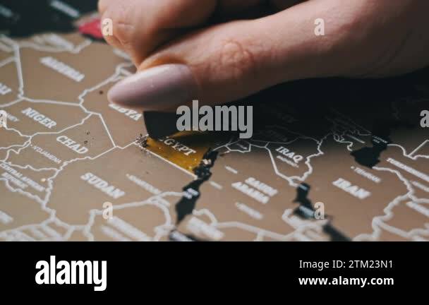 Scratching Egypt Country on the Surface of Scratch World Map. Woman ...