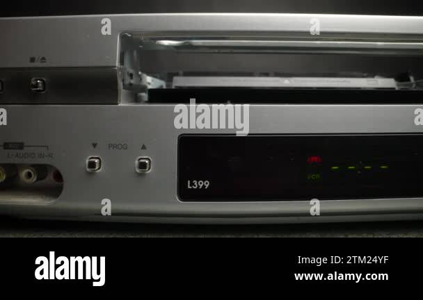 Taking a VHS cassette out of an old VCR. Dolly shot. Close-up Stock ...