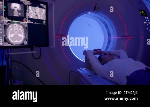 4k video CT scan of brains of woman in medical clinic with blue light ...