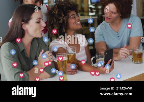 Animation of social media icons over group of diverse friends enjoying ...