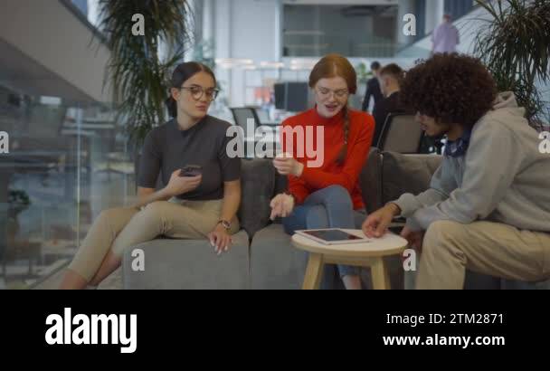 A diverse group of colleagues exchange business experiences, engage in ...