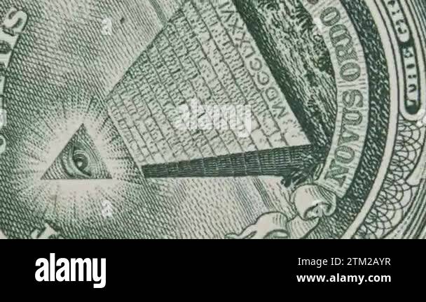 The all-seeing eye sign rotates on a one dollar bill close-up. Mason ...