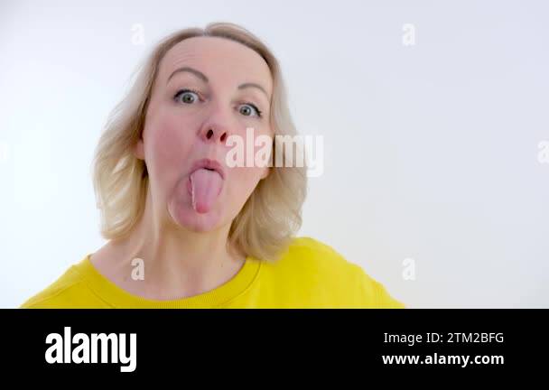 tease disagree woman sticks out tongue laughs sticks out eyes make ...