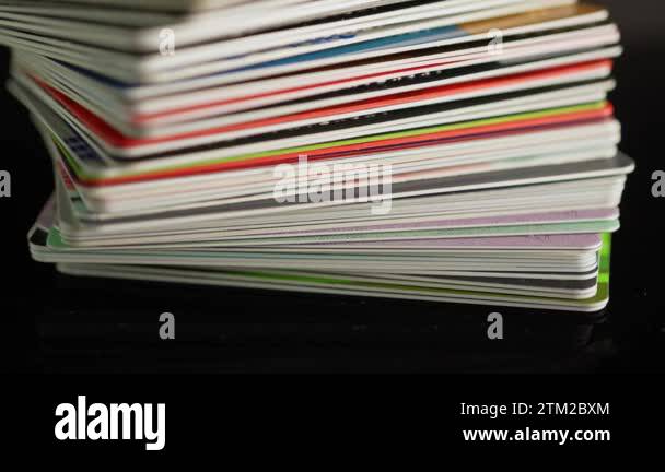 Credit and debit plastic cards pile on the table, slowly rotation ...