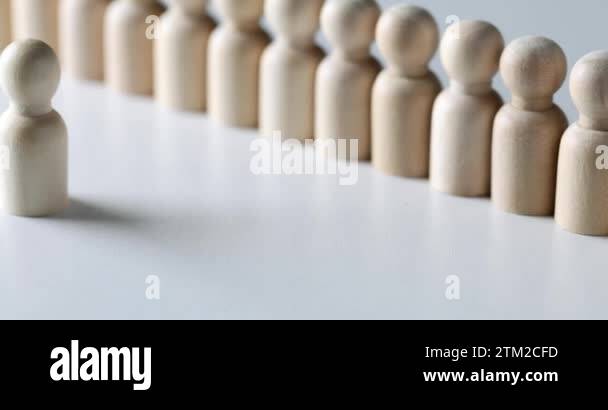 Conceptual image of person standing out from crowd of identical people ...