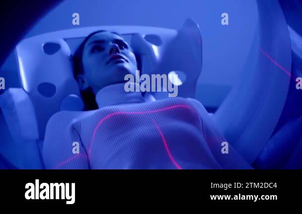 4k video CT scan of brains of woman in medical clinic with blue light ...