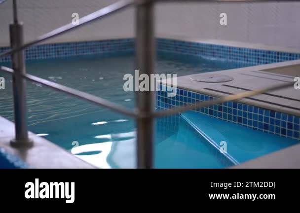 Swimming pool with bubbling waves in Roman steam room indoors. No ...