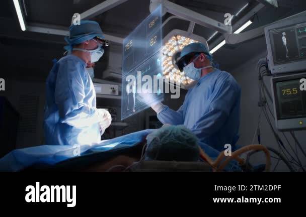 Doctors perform surgery in hospital operating room wearing AR headsets ...