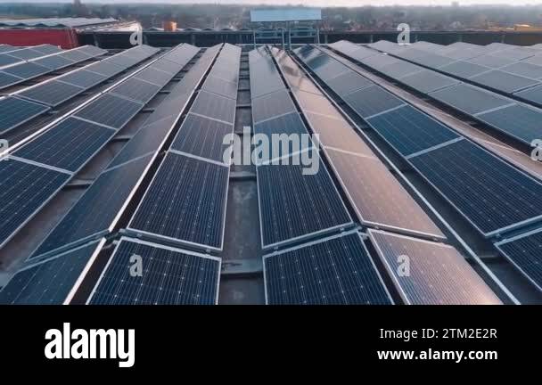 Rows of solar panels on roof at sunset. Photovoltaic green energy ...