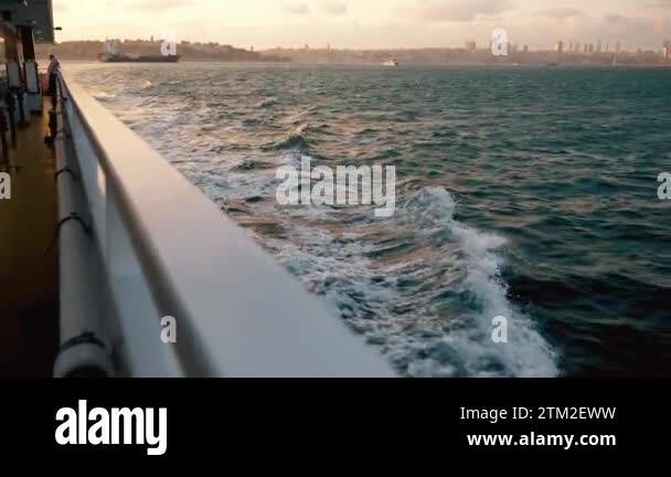 Top view of deck and side of wooden boat sailing on sea. Ship cuts ...