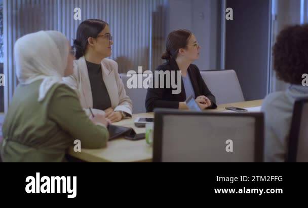 A diverse group of colleagues exchange business experiences, engage in ...