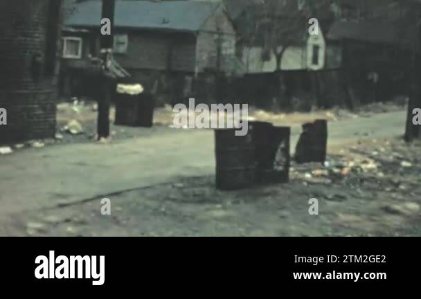 Old single-storey houses with dirty roads and poles with messy cables ...