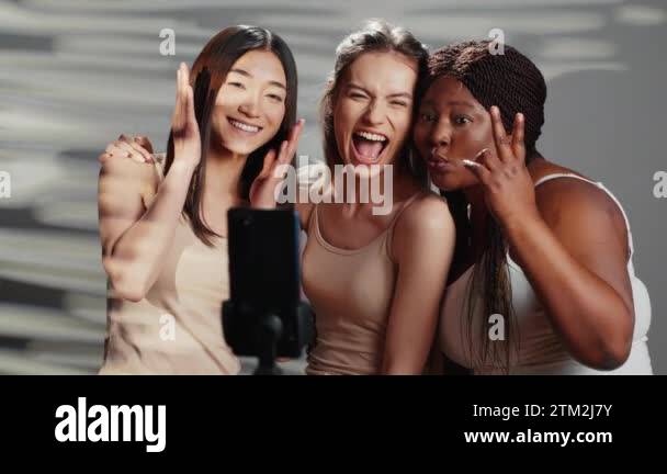 Interracial Group Of Friends Taking Photos On Smartphone To Promote