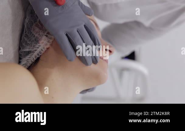 Beautician makes micro-current face lifting therapy with conductive ...