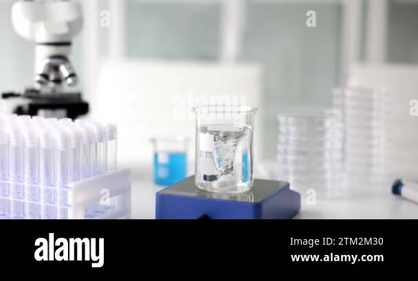 Flask with stirrer for liquid with water in laboratory. Technique of ...