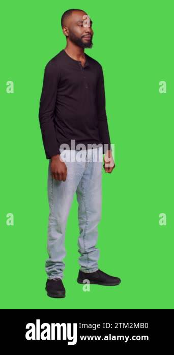 Vertical video: Side view of african american person smiling in studio ...