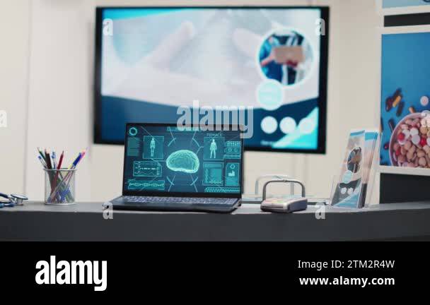 Registration desk with brain on laptop, showing neurology x ray scan ...