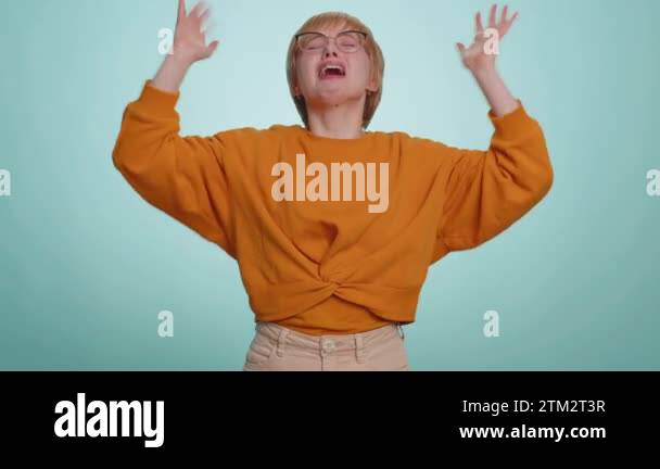 Young woman scared fearful, covering ears with hands, closing eyes ...