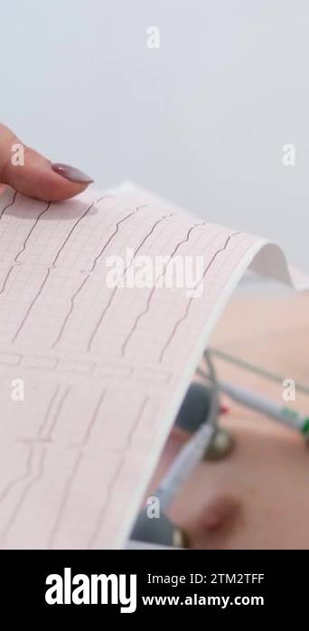 cardiogram in the hospital woman doctor examines a man patient puts ...