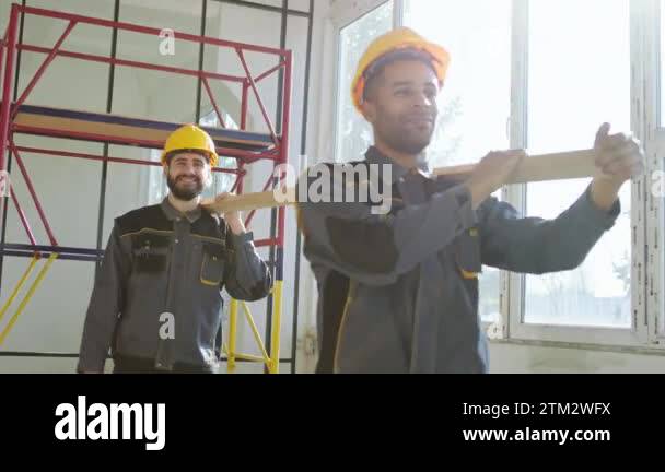At construction site two young and charismatic men multiracial ...