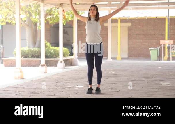 Video of fit woman performing arm rotation exercise, swinging forward ...