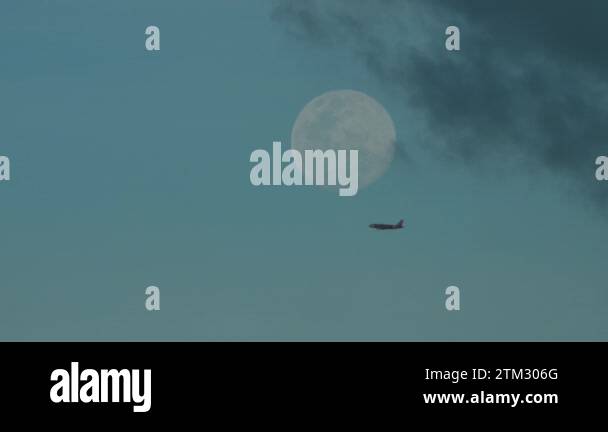 Super full moon over Thailand and silhouette of airplane. A commercial ...