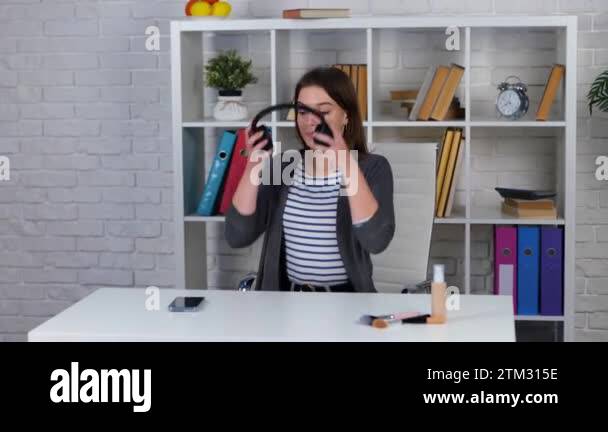 Smiling young woman listening positive music songs while recording ...
