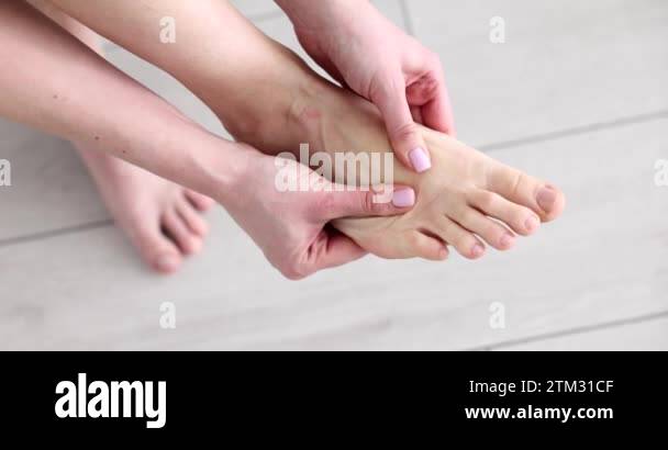 Woman doing foot massage with hands at home closeup 4k movie slow ...