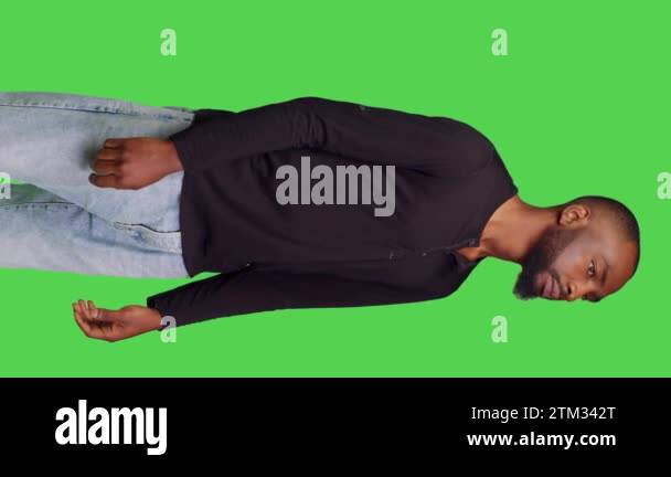 Vertical video: Side view of male model feeling pensive thinking about ...