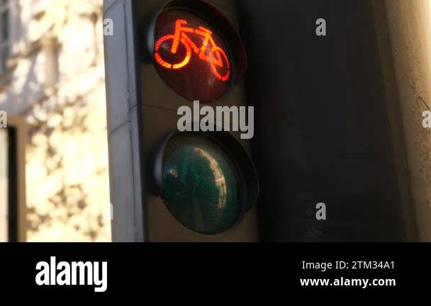 Bicycle traffic light signal switching from red stop light to green go ...