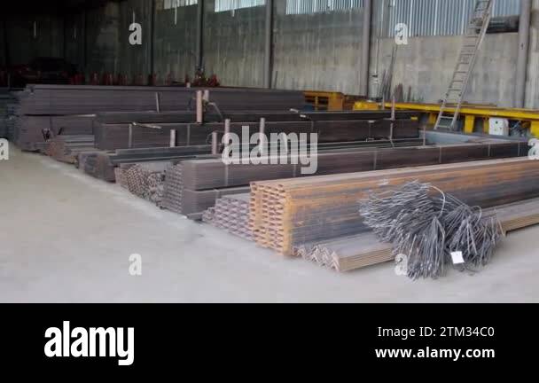 Piles of metal construction fittings in a warehouse of a construction ...