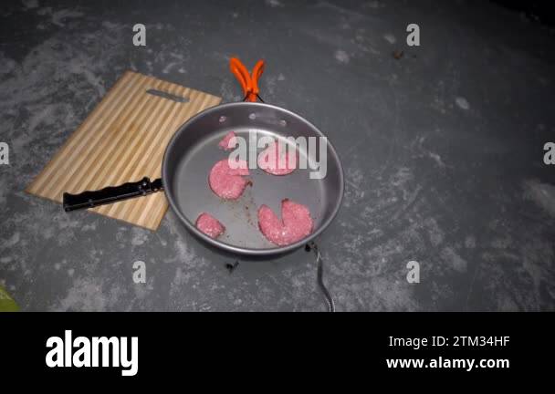 A guy cooks food on gas inside an ice cave. The climber lights the ...