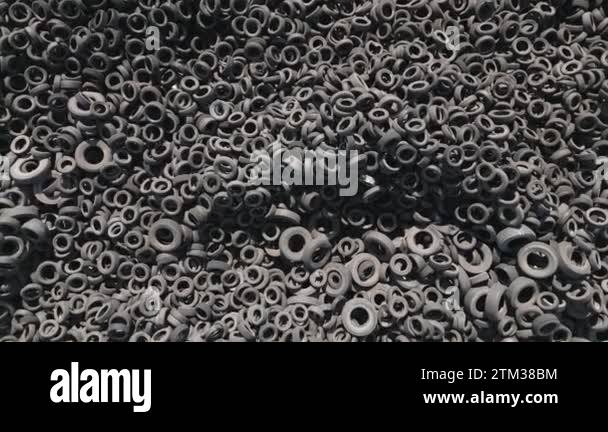 This striking top-down view captures a massive dump of car tires ...